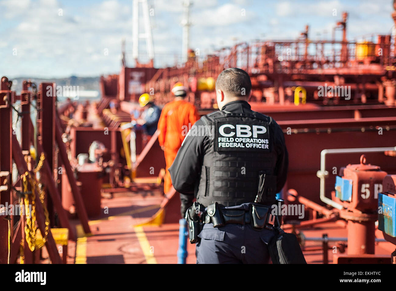 A CBP Officer conducts an immigration inspection at the Port of New ...