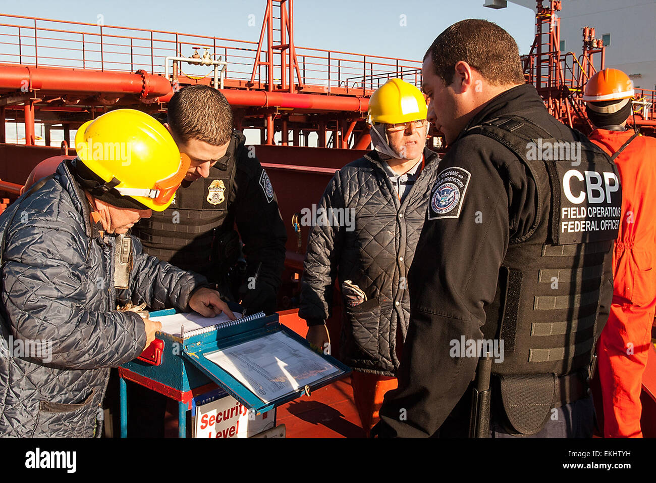Two U.S. Customs and Border Protection officers sign into a log book at ...