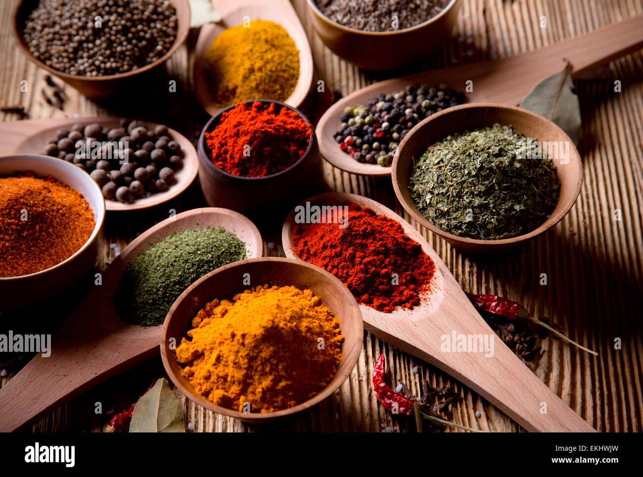 Assorted spices on wooden background Stock Photo - Alamy