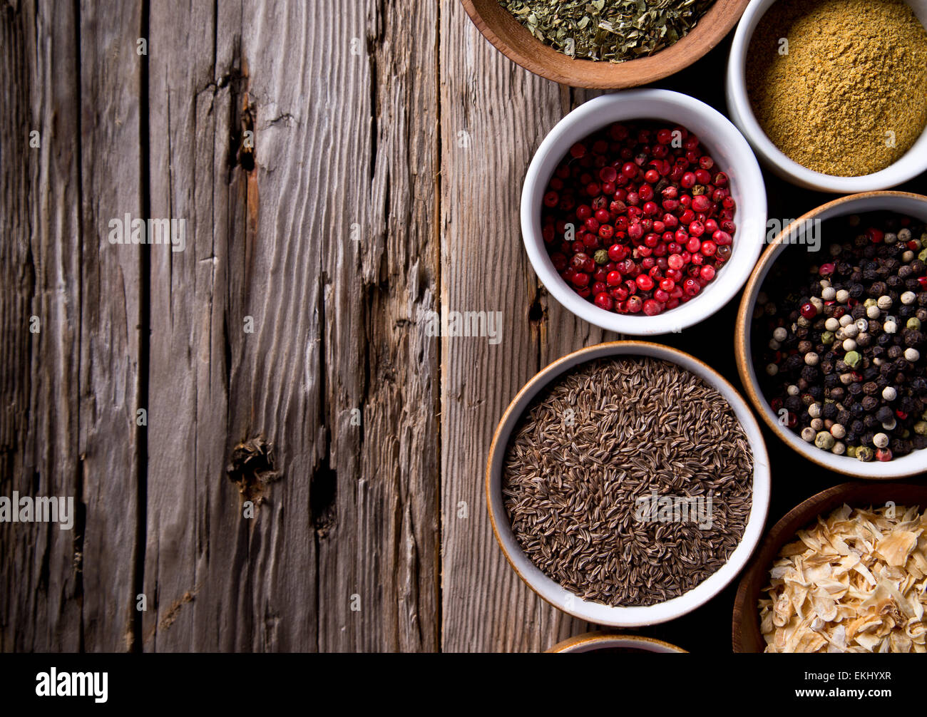 Assorted spices on wooden background Stock Photo - Alamy