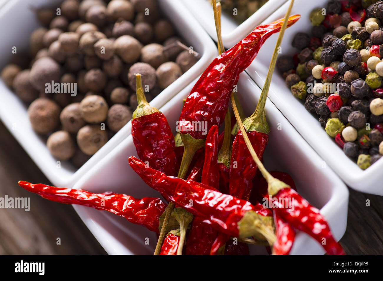 Assorted spices on wooden background Stock Photo - Alamy