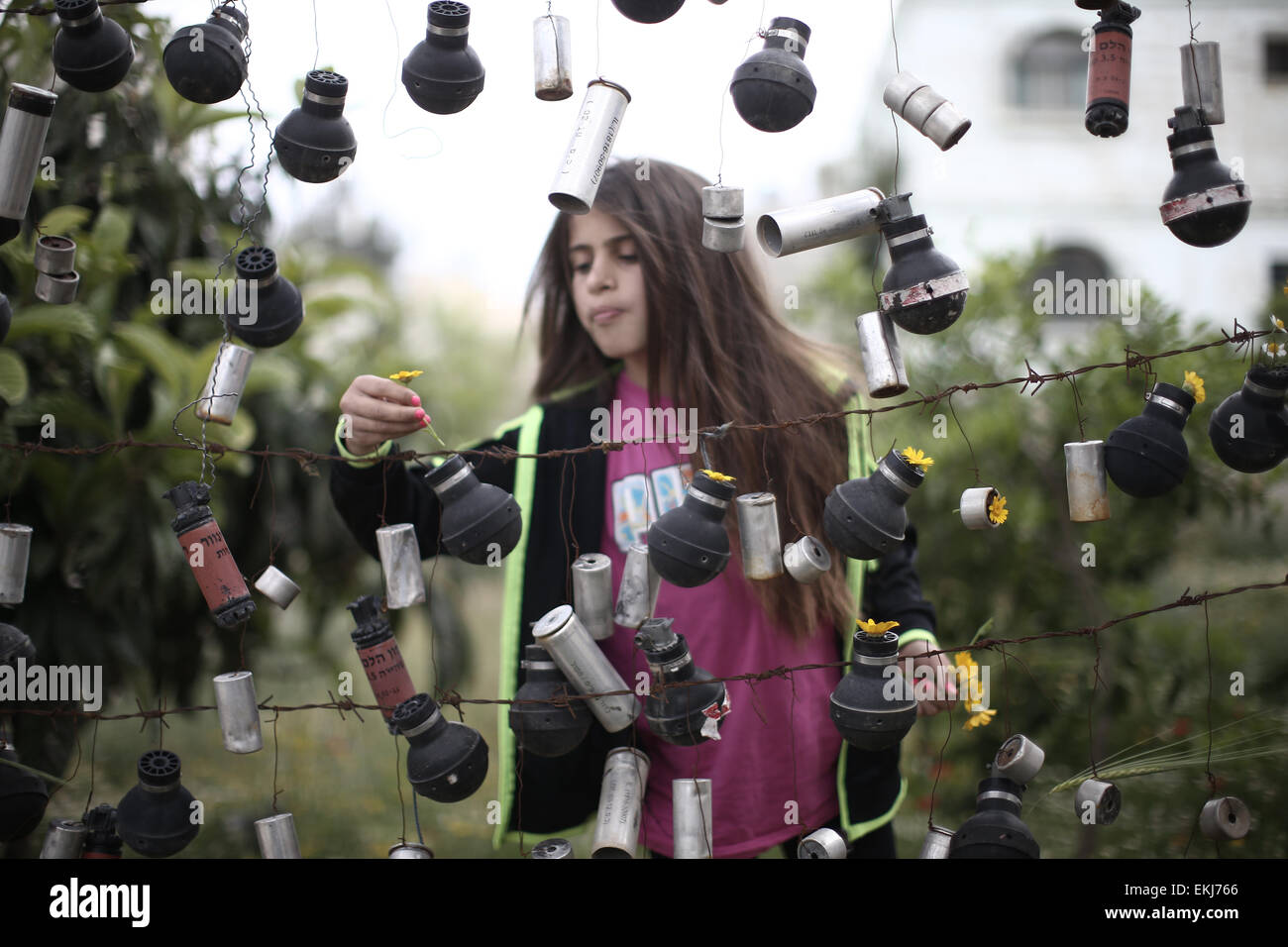 Ramallah. 11th Apr, 2015. A Palestinian girl places flowers inside used ...