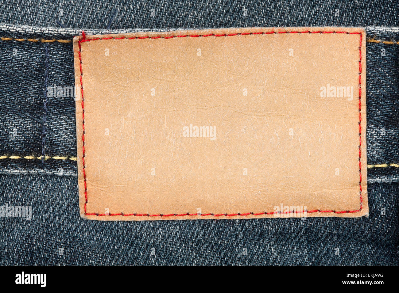 Blank leather jeans label sewed on a blue jeans Stock Photo - Alamy