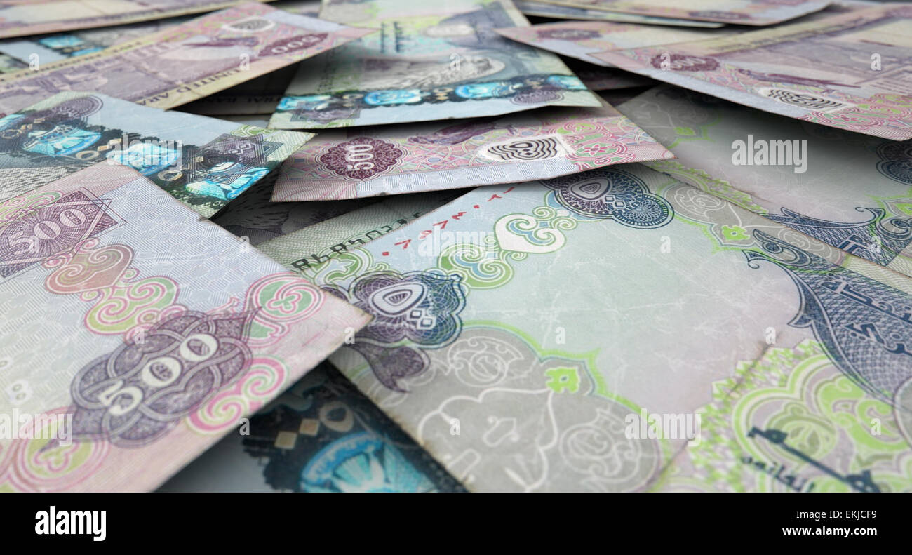 A macro close-up view of a messy scattered pile of dirham banknotes ...