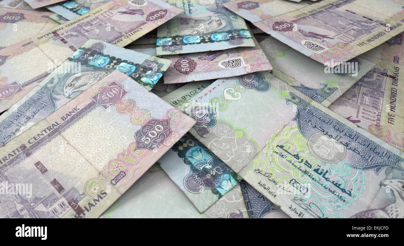 A macro close-up view of a messy scattered pile of dirham banknotes ...