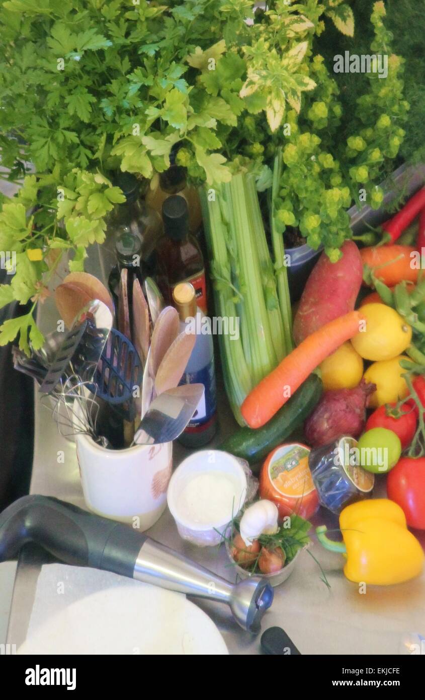 Kitchen vegetables, fruit, garden herbs, and utensils preparation for ...