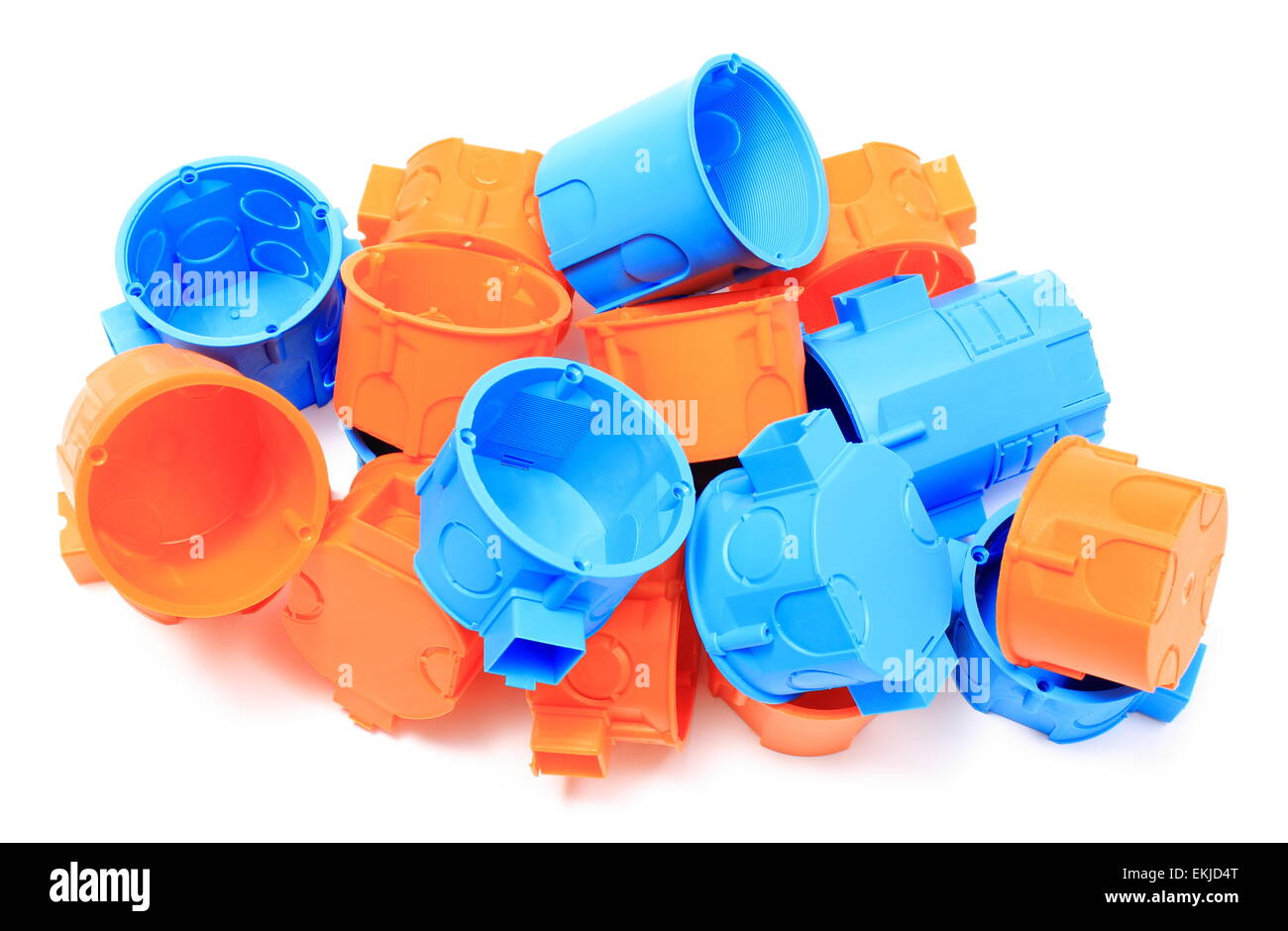 Heap of blue and orange plastic electrical boxes on white background ...