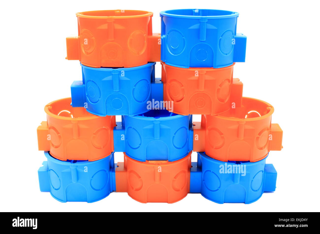 Stack of orange and blue plastic electrical boxes on white background ...