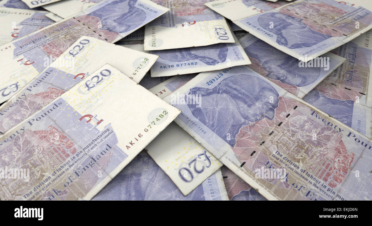 A macro close-up view of a messy scattered pile of british pound ...