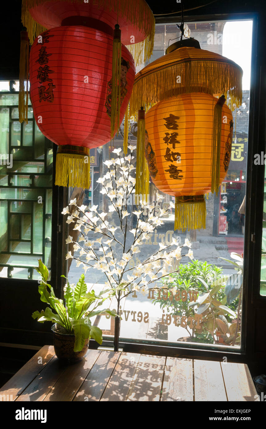 Late afternoon sun lights restaurant window in the ancient walled city ...
