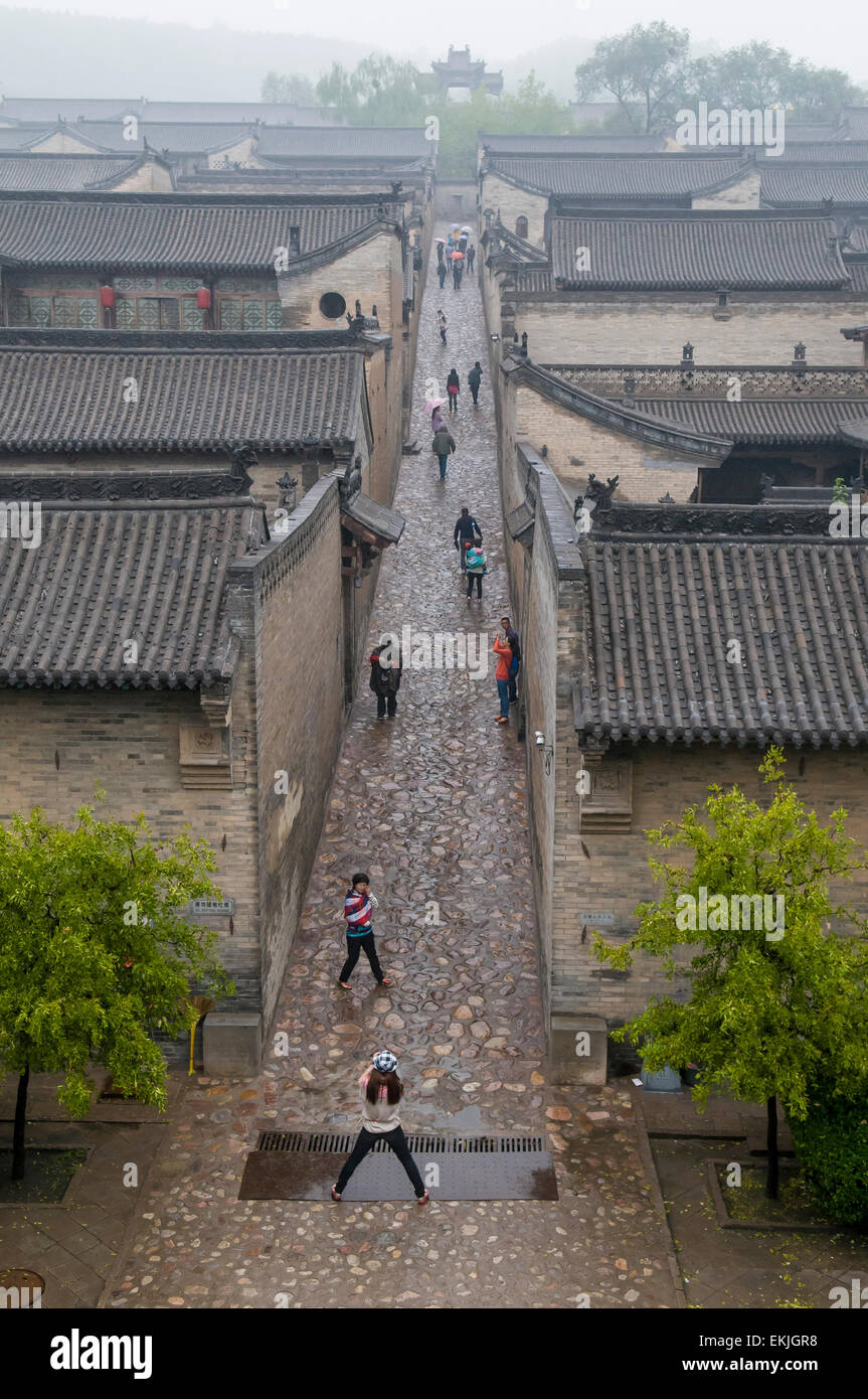 Chinese tourists brave rain at the Wang Family Courtyard Home, Linshi ...