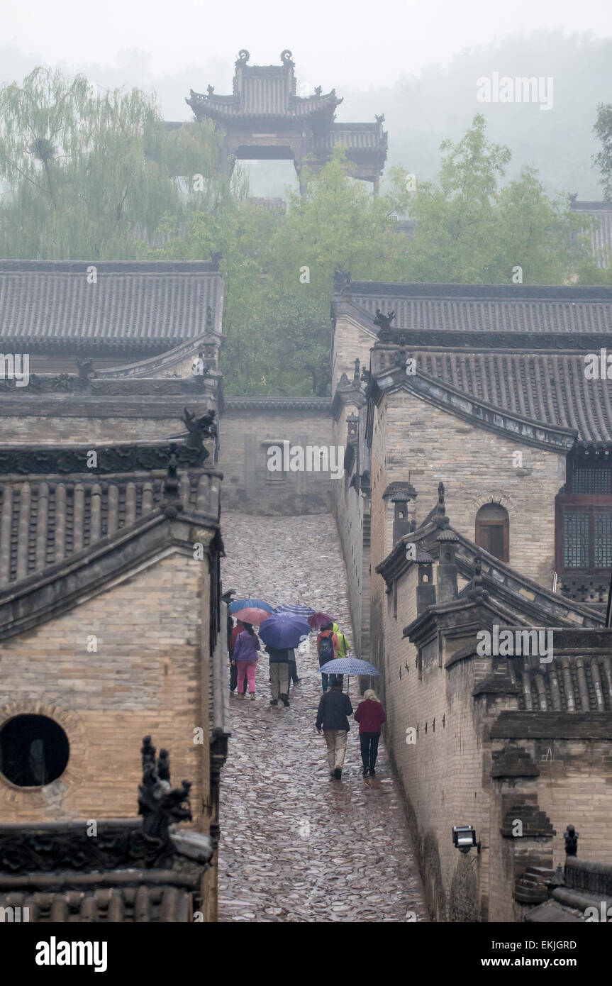 Chinese tourists brave rain at the Wang Family Courtyard Home, Linshi ...