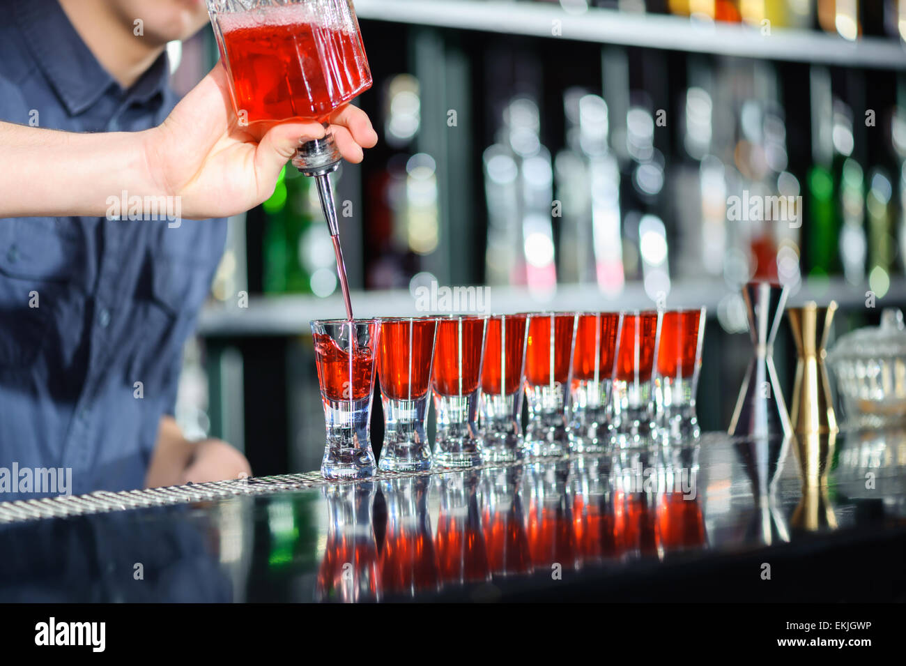 Barman makes shots in a bar Stock Photo - Alamy
