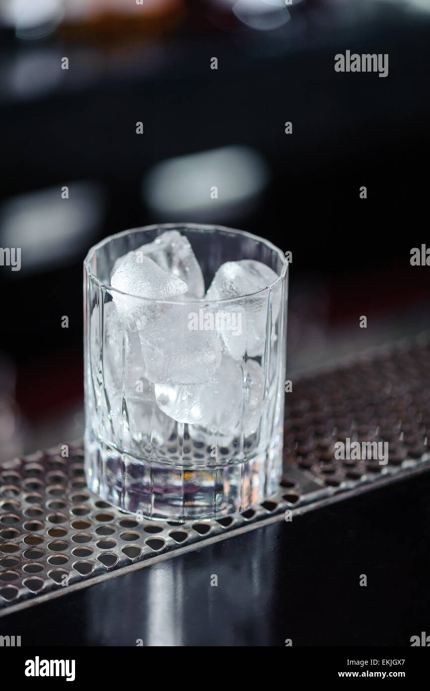 Glass with ice in a bar Stock Photo - Alamy