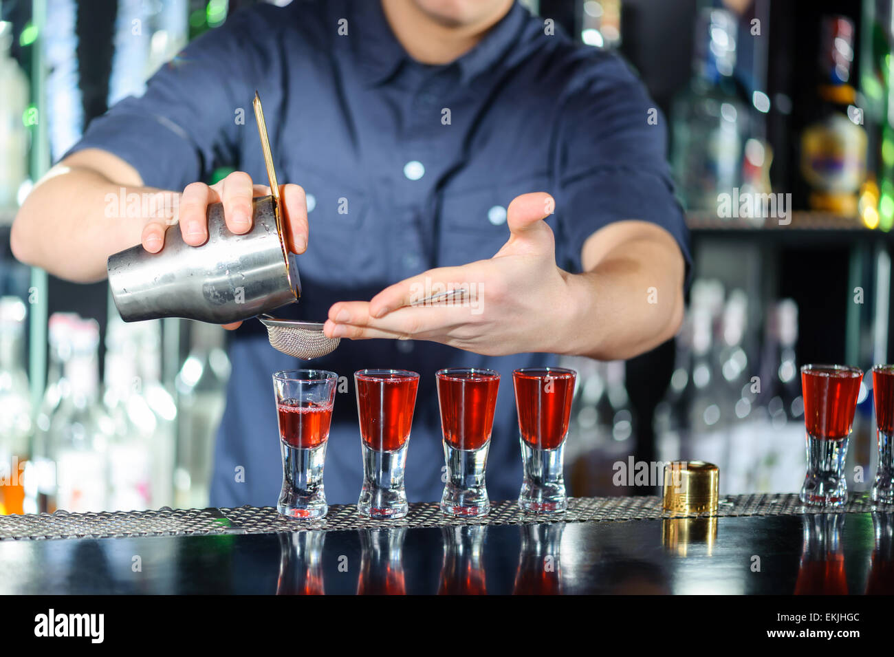 Barman makes shots in a bar Stock Photo - Alamy
