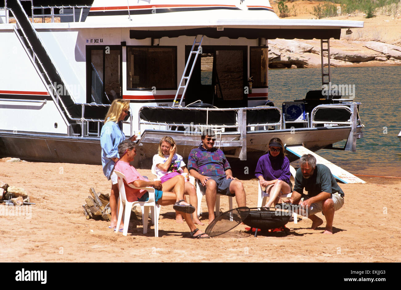 Houseboaters enjoy a cookout on a beach in Dungeon Canyon, Lake Powell ...
