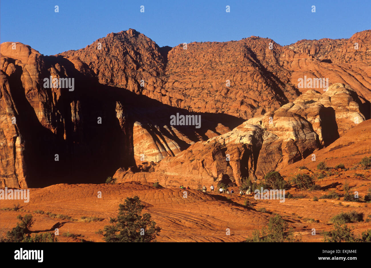 Red Rock formations dwarf hikers at Petrified Sand Dunes, Snow Canyon ...