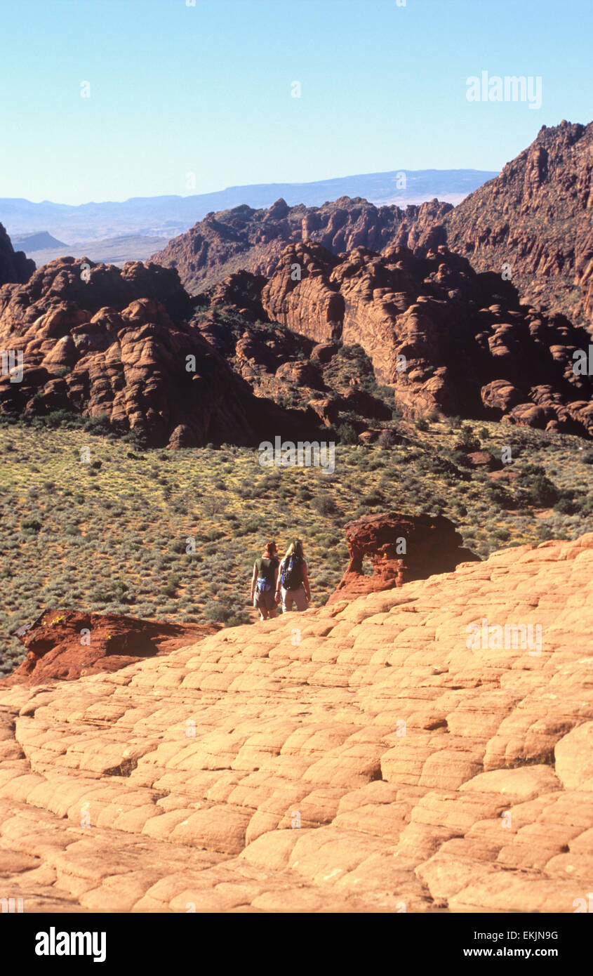 Red Rock formations dwarf hikers at Petrified Sand Dunes, Snow Canyon ...