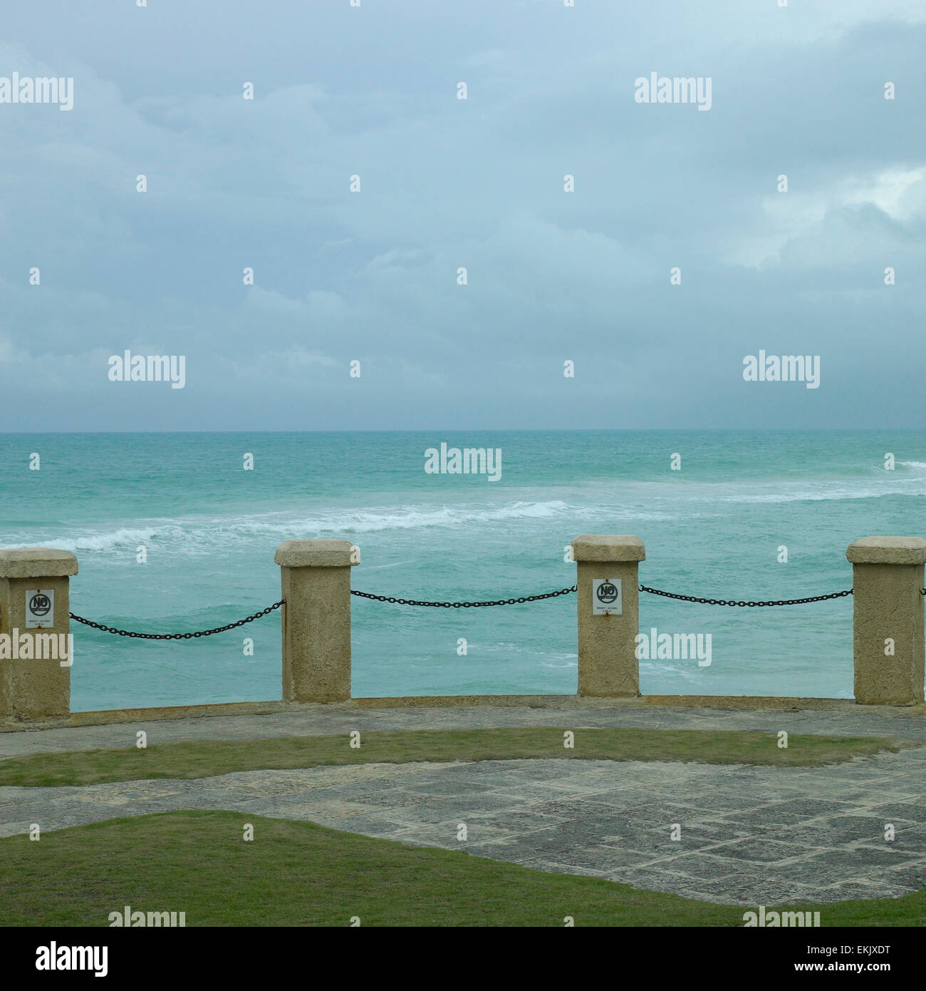 Pillar and chain fence overlooking the tropical ocean Stock Photo - Alamy