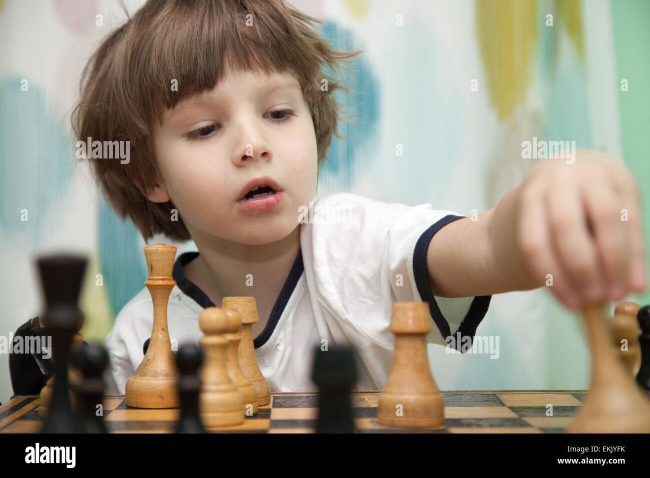 Portrait of a little boy playing chess Stock Photo - Alamy