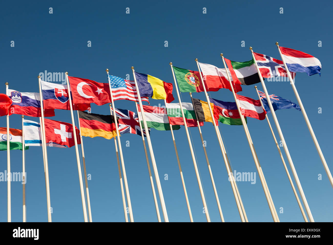 flags of different countries on flagpoles fluttering in the wind Stock ...