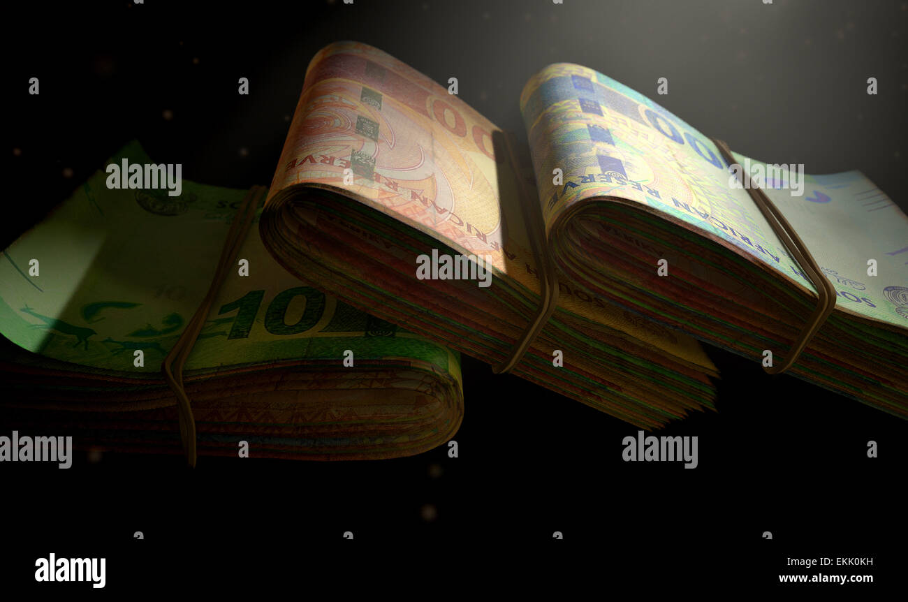 A close-up view of three wads of folded over stacks of south african ...