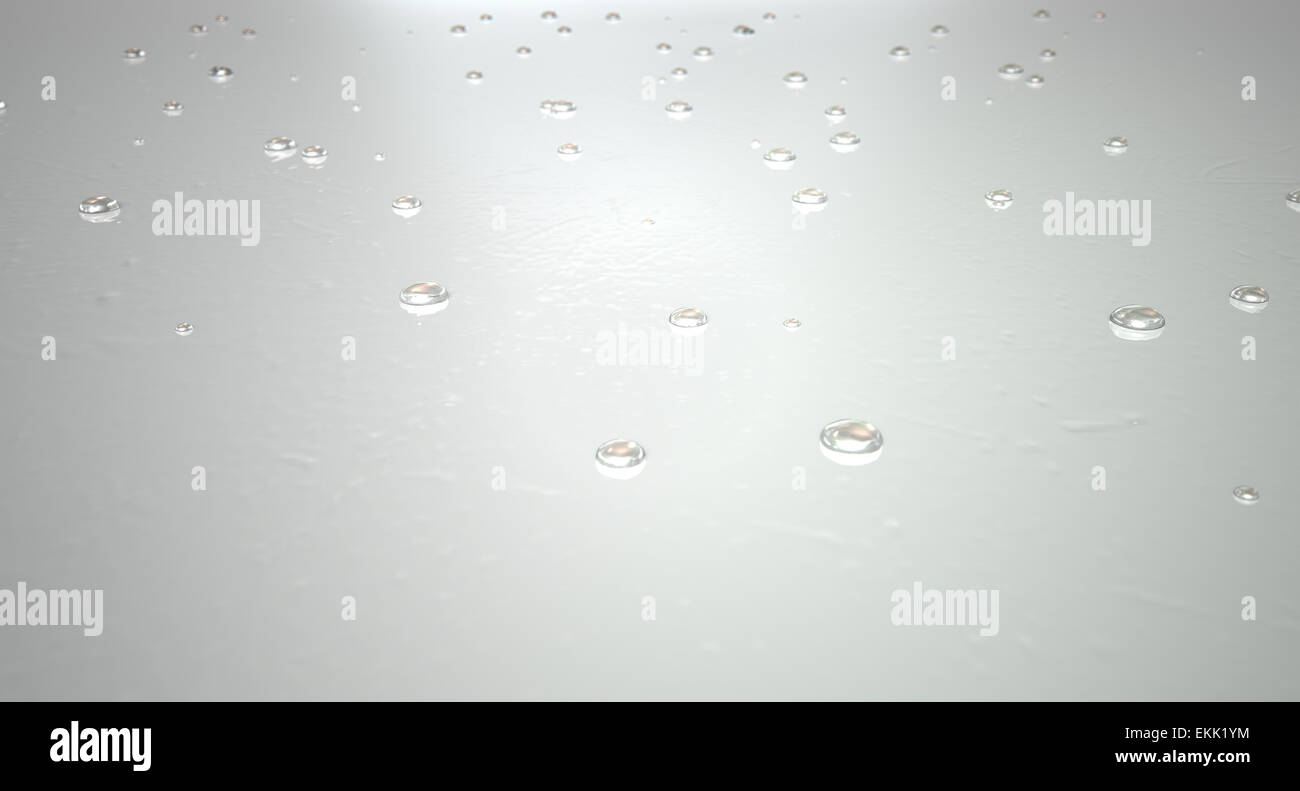 A collection of various size droplets of water on a reflective white ...