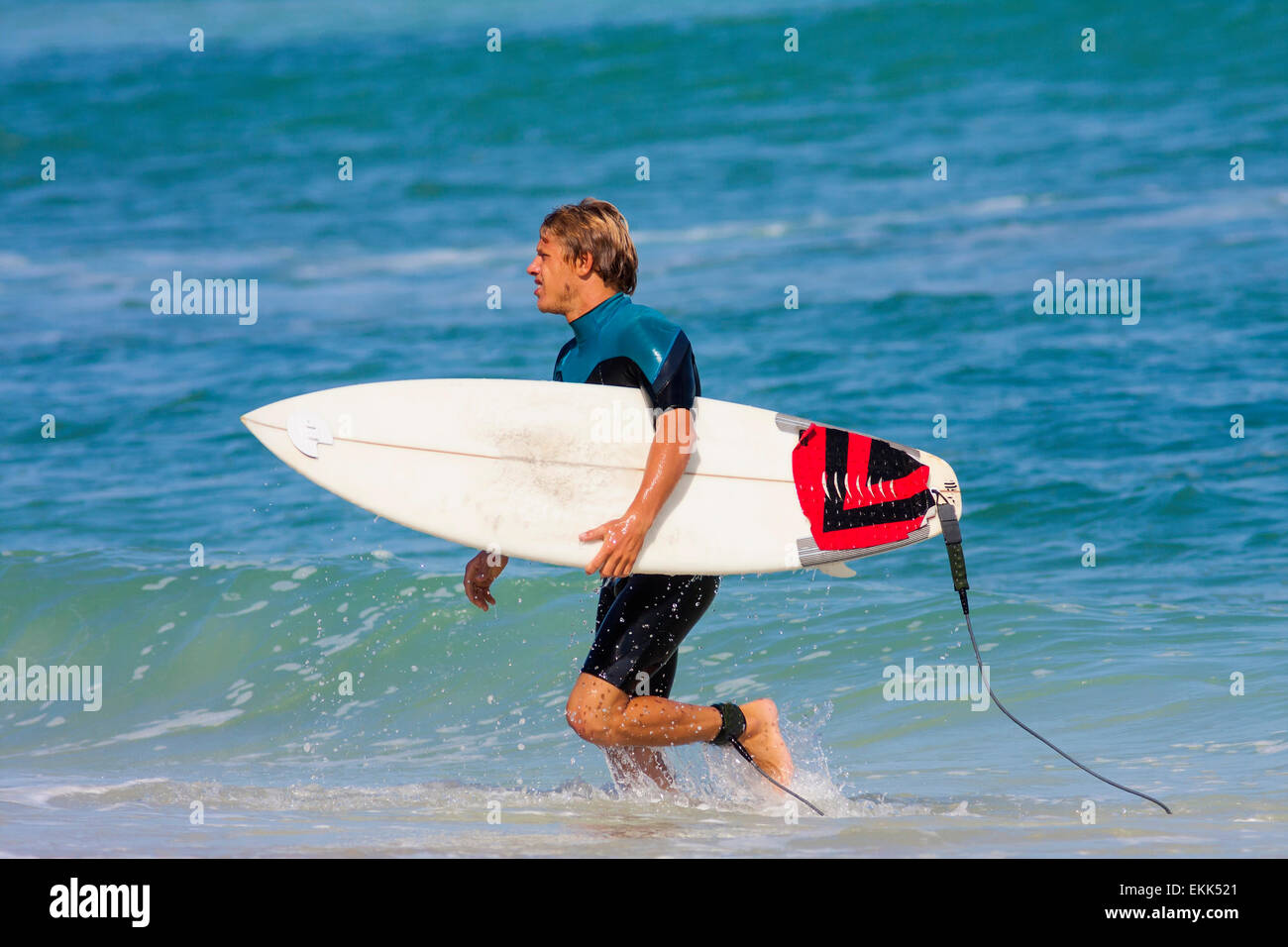 Surfers on a beach Stock Photo - Alamy