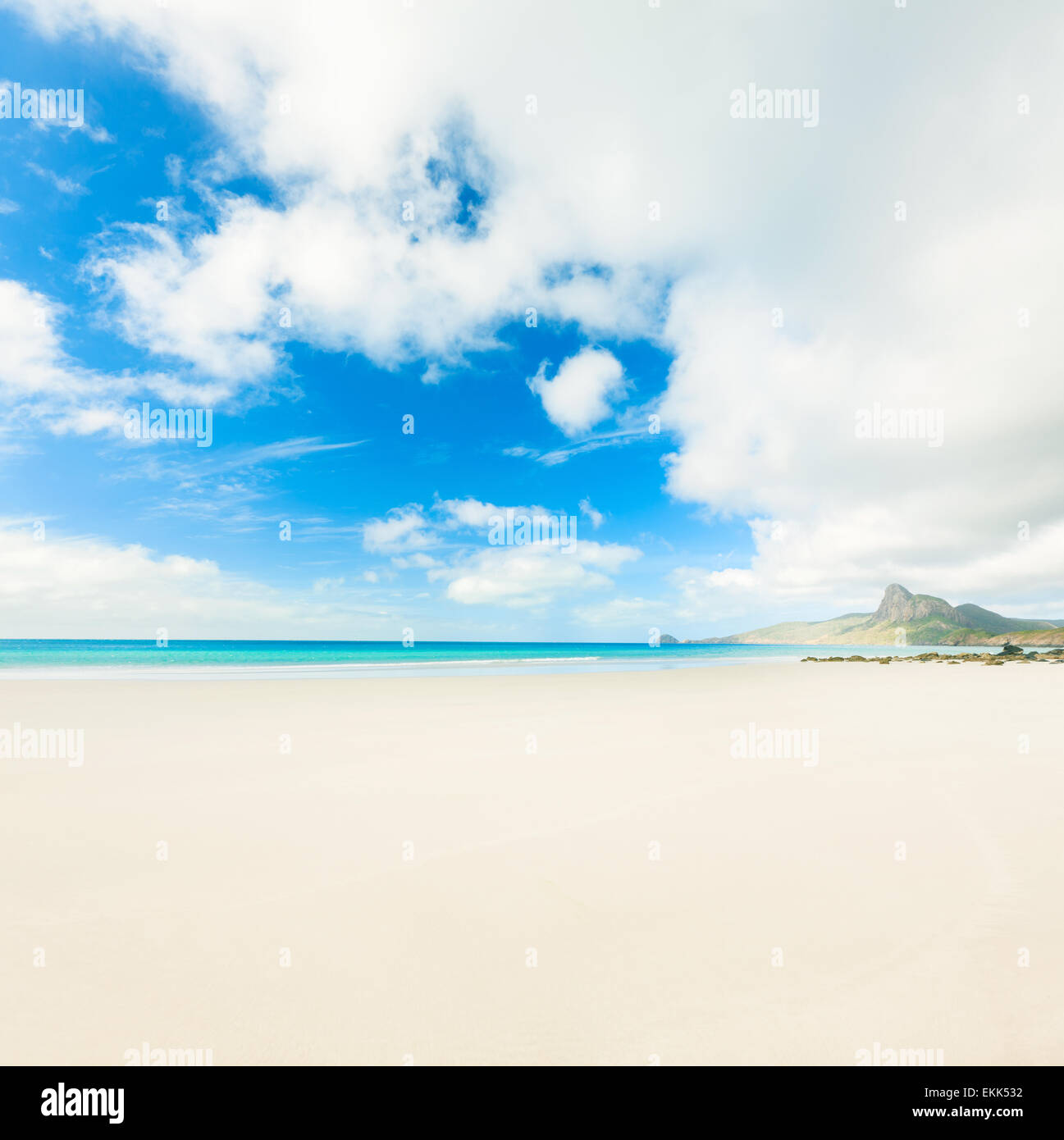 Beautiful white sand beach. Island on background Stock Photo - Alamy