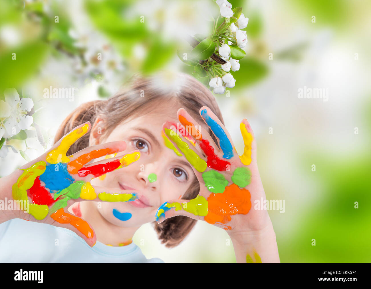 Beautiful little girl painting with spring blossoms Stock Photo - Alamy
