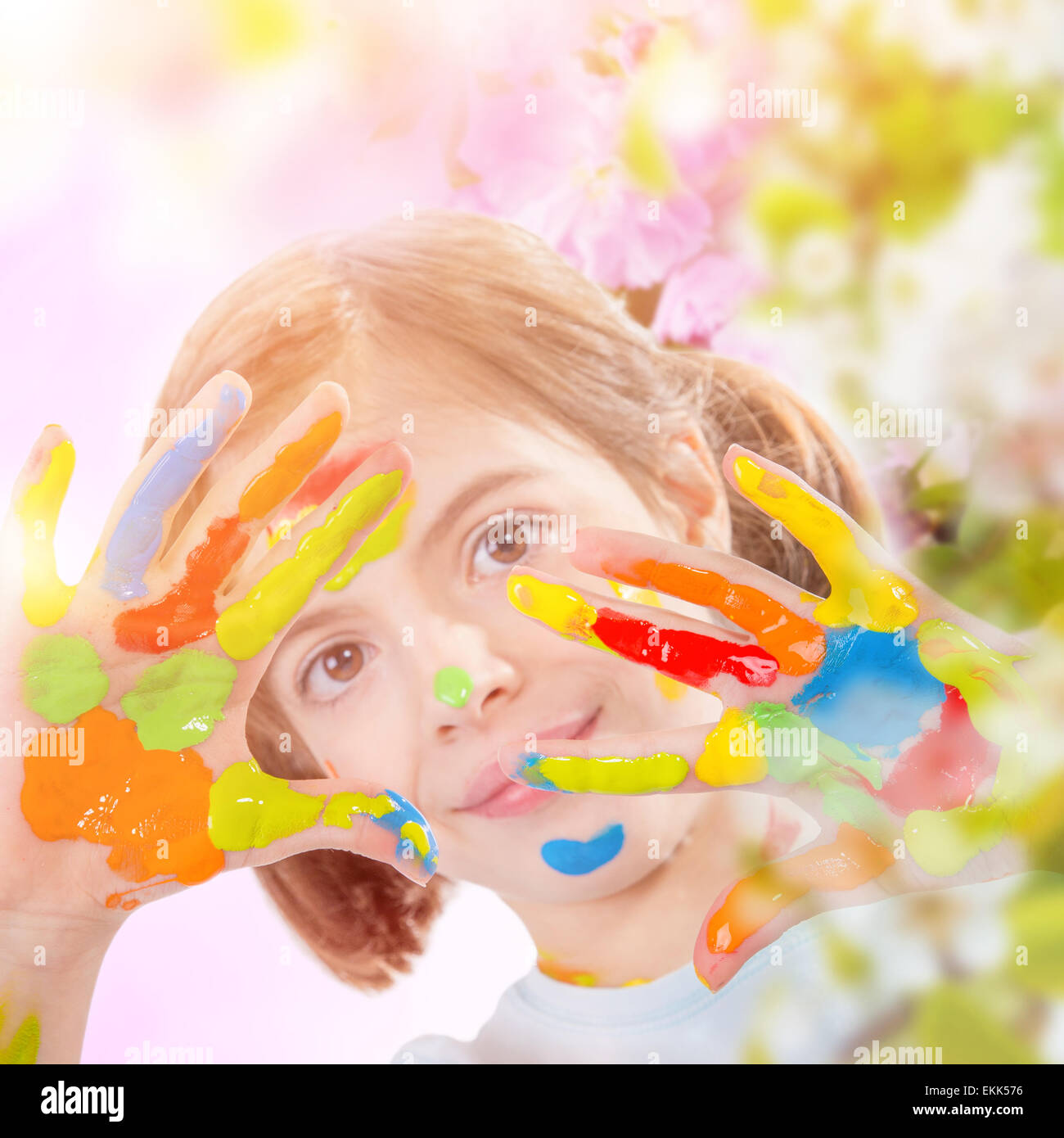 Beautiful little girl painting with spring blossoms Stock Photo - Alamy