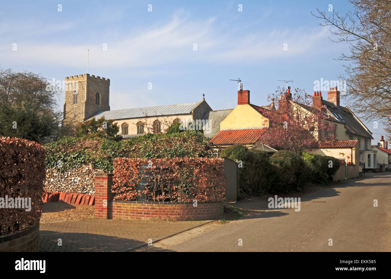 A village scene with church and houses in the Norfolk Broads at Ludham ...