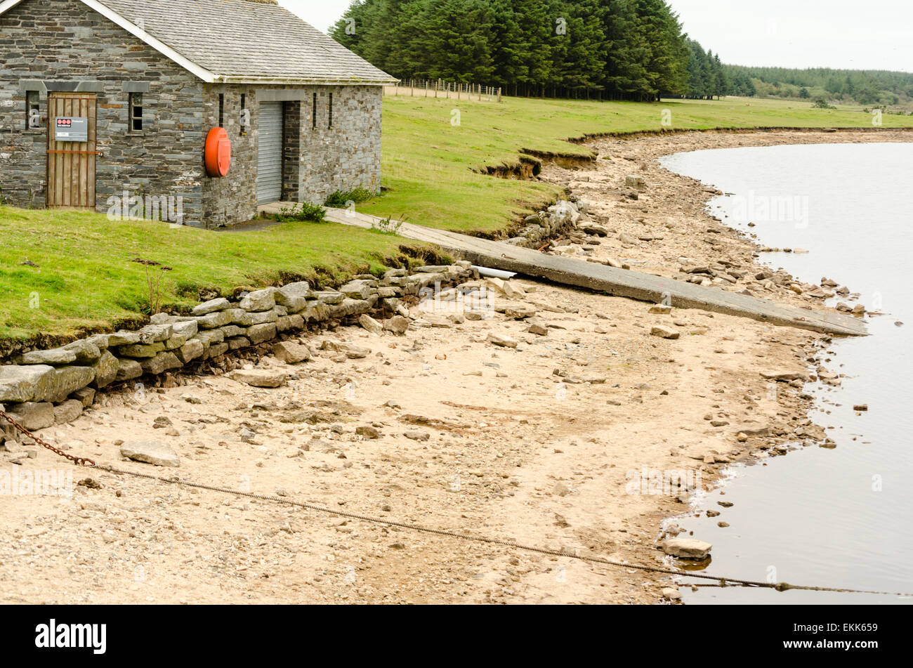 Landscape image of a boat house with a jetty heading across the small ...