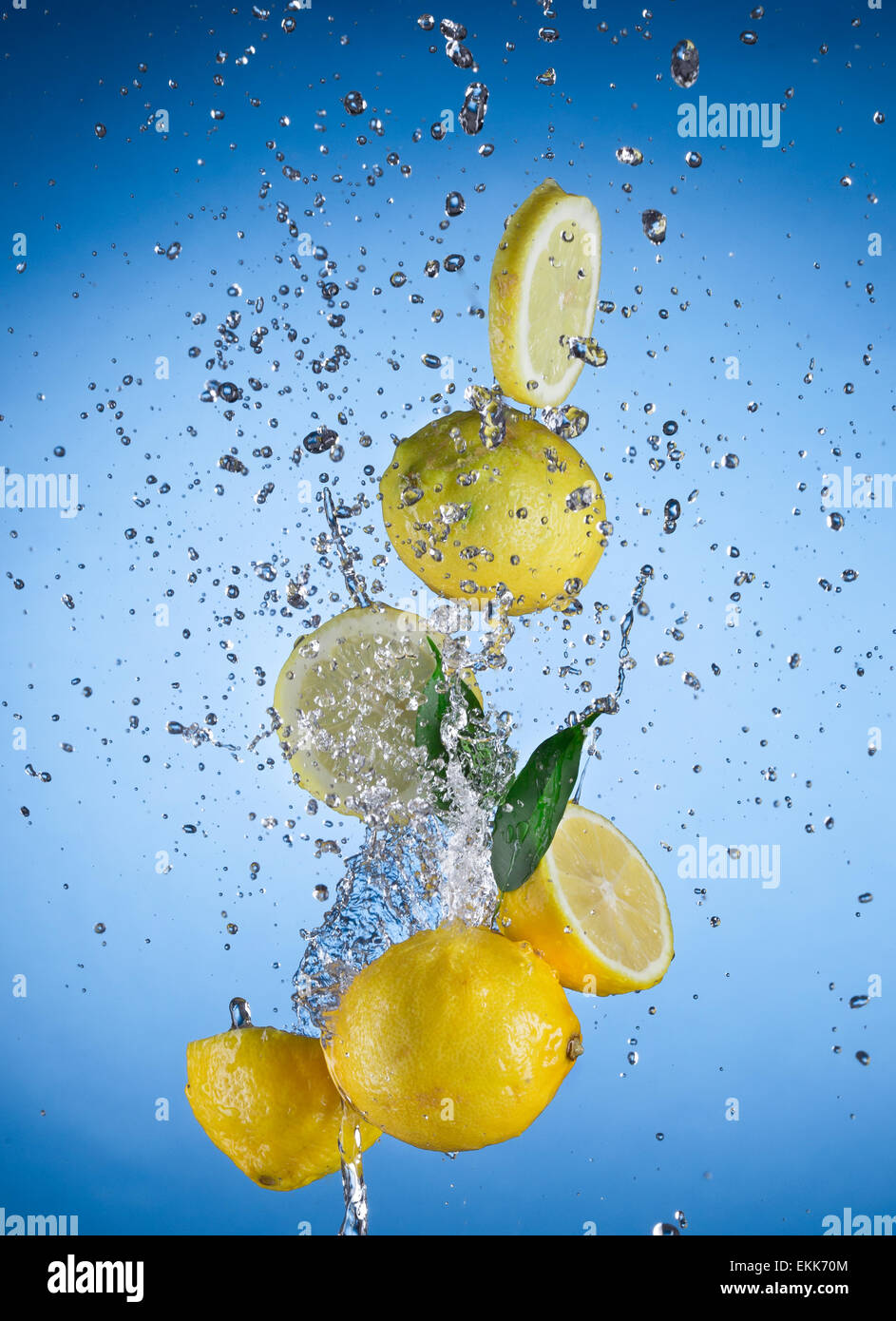 Lemon with water splash isolated on blue Stock Photo - Alamy