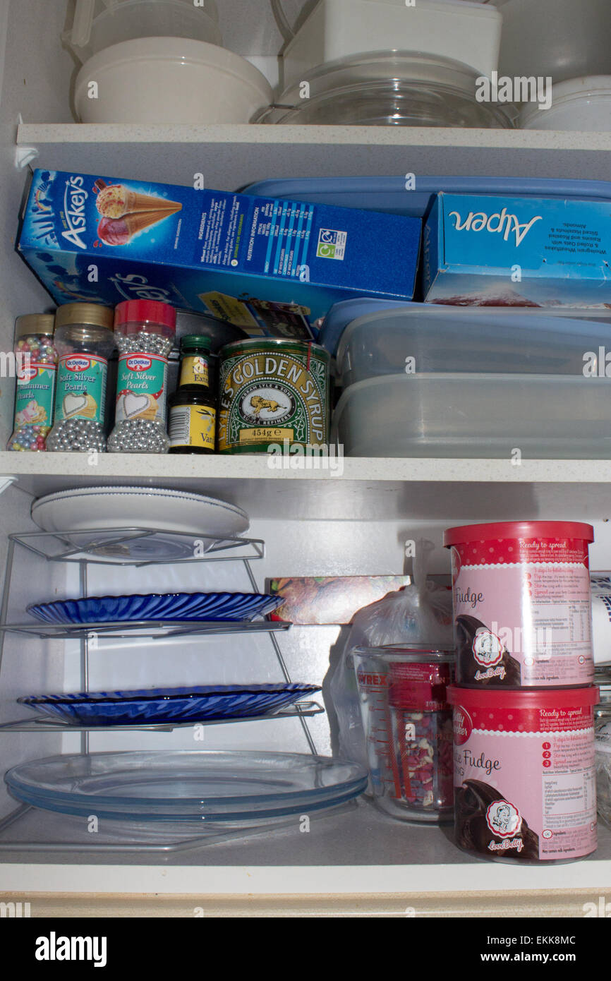 The contents of a kitchen cupboard including cooking ingredients ...