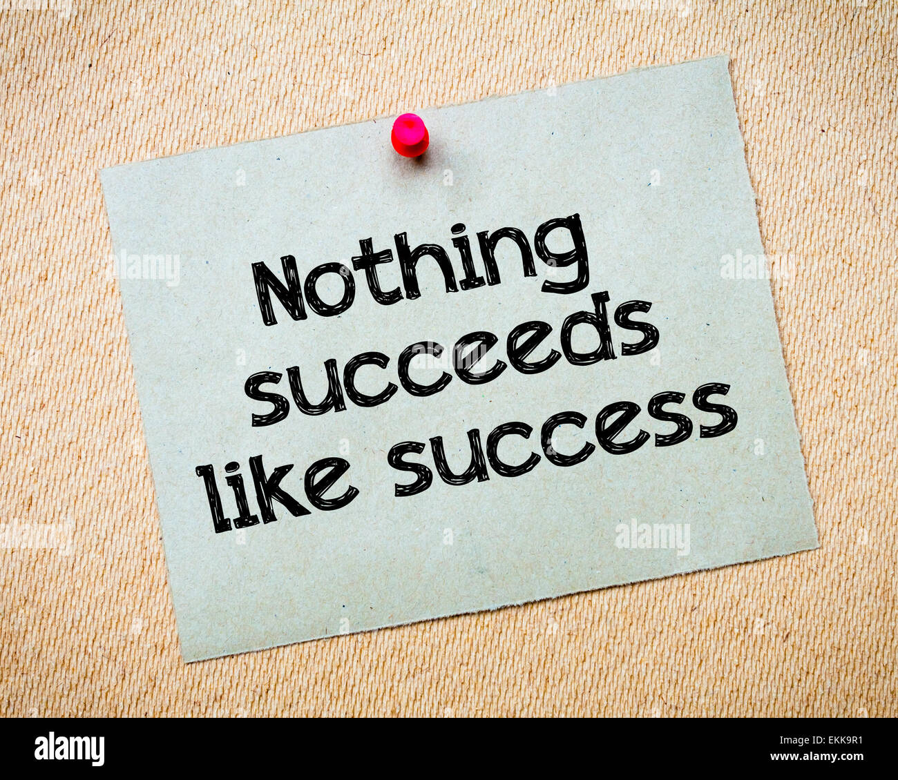 Nothing succeeds like success Message. Recycled paper note pinned on ...