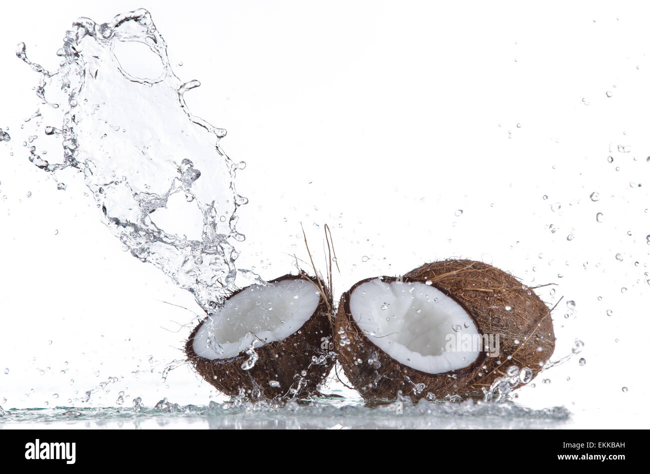 Coconuts with water splash isolated on white Stock Photo - Alamy