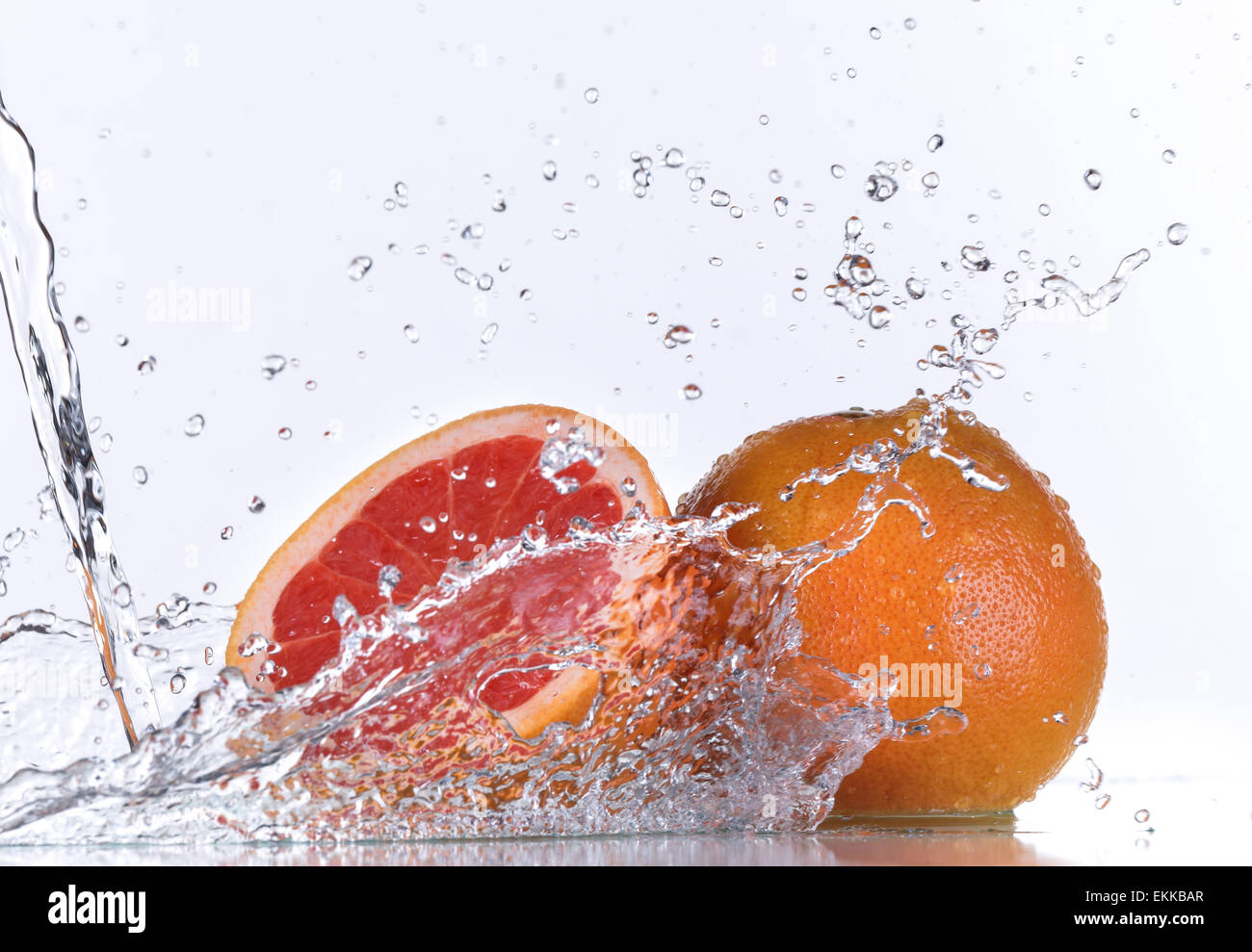 Grapefruit with water splash isolated on white Stock Photo - Alamy
