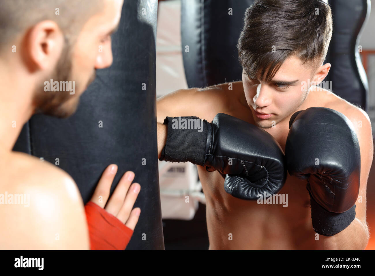 Boxing coach trains his team Stock Photo - Alamy