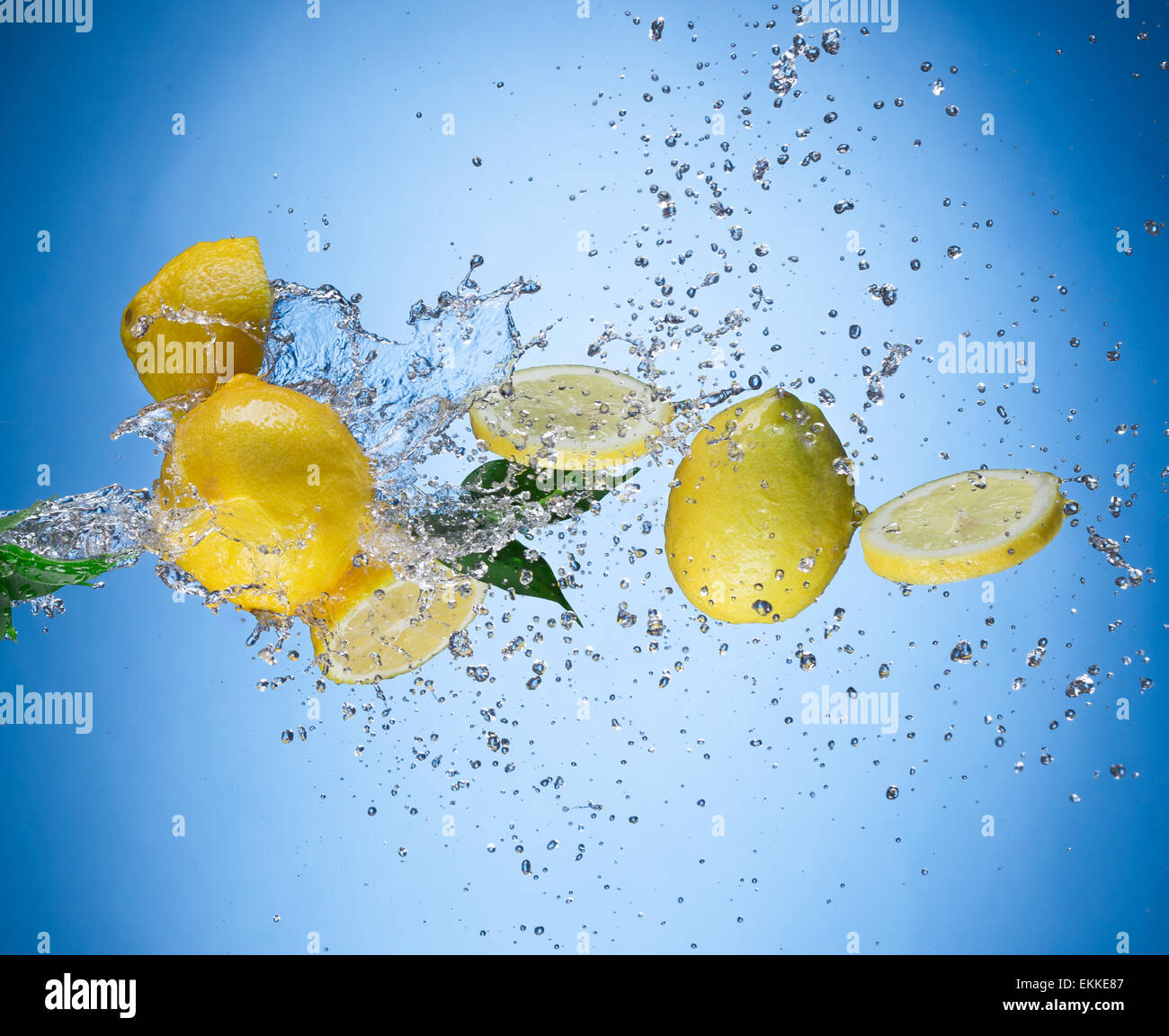 Lemons with water splash on blue background Stock Photo - Alamy