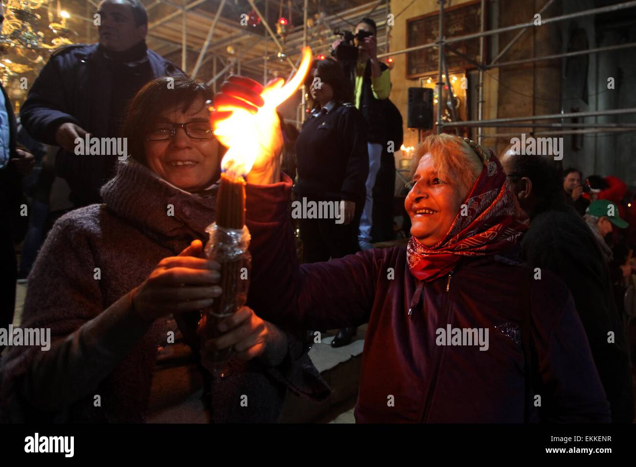 Bethlehem. 11th Apr, 2015. Christian pilgrims touch the Holy Fire at ...
