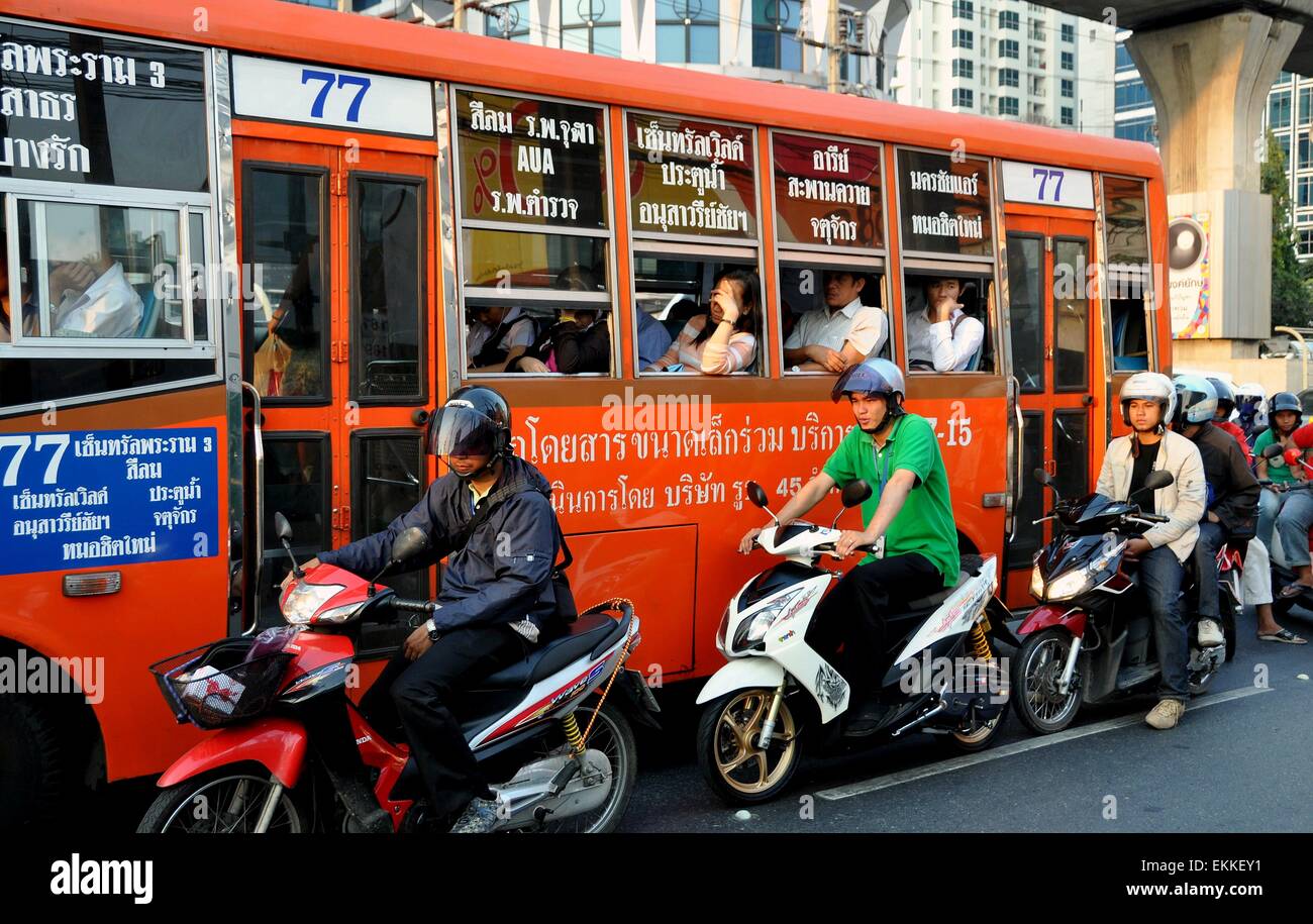 Bangkok, Thailand : Thai riders on their mopeds next to a Bangkok city ...