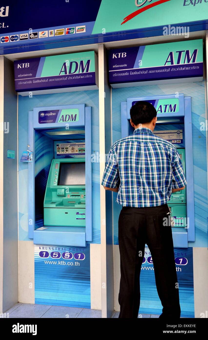 Bangkok, Thailand: Man withdrawing cash from an ATM automatic teller ...