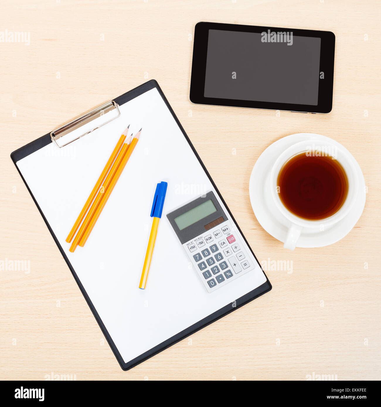 business still life - top view of tablet PC, clipboard, calculator, cup ...