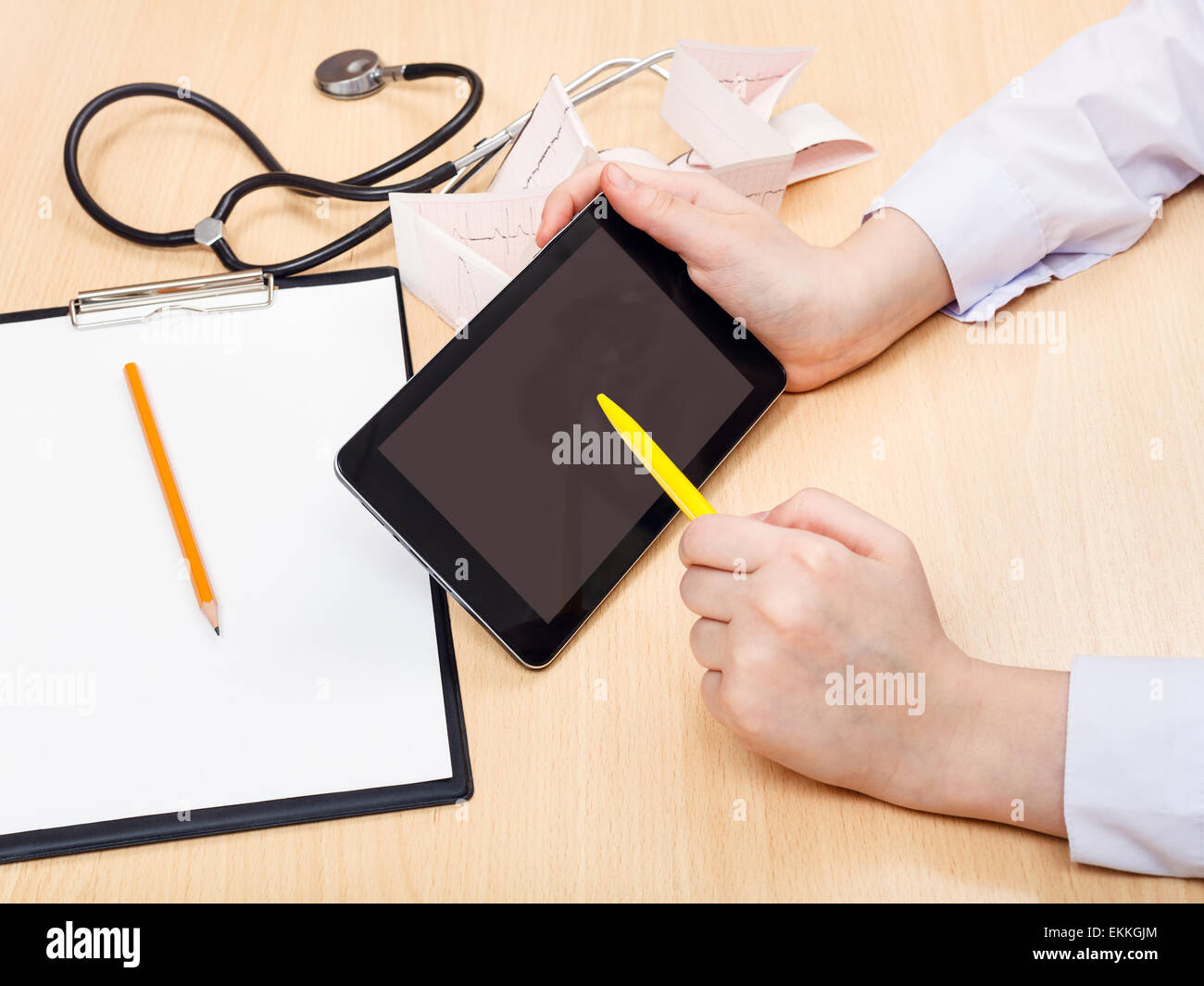 doctor works with tablet pc during appointment Stock Photo - Alamy