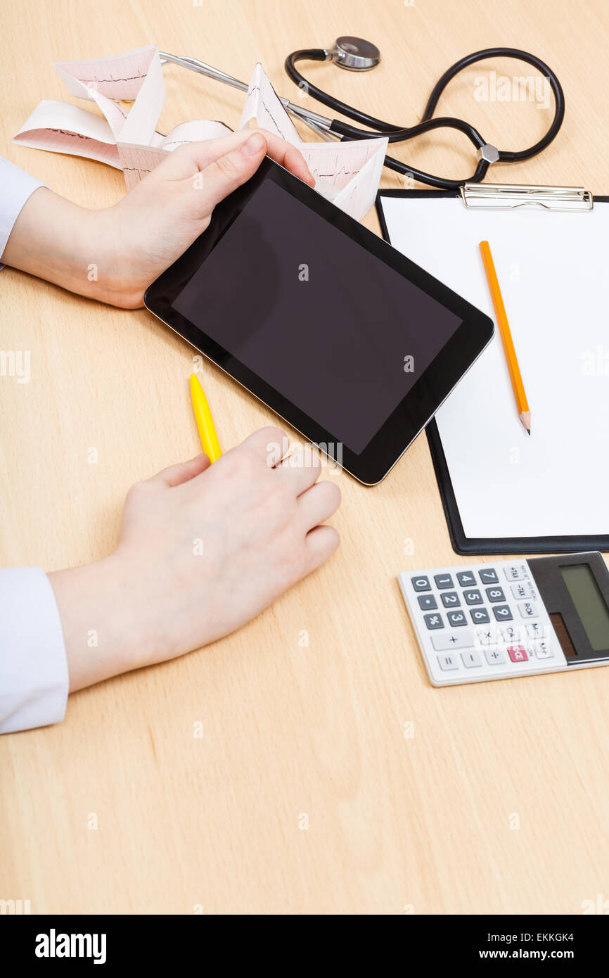 physician calculates with tablet pc during appointment Stock Photo - Alamy