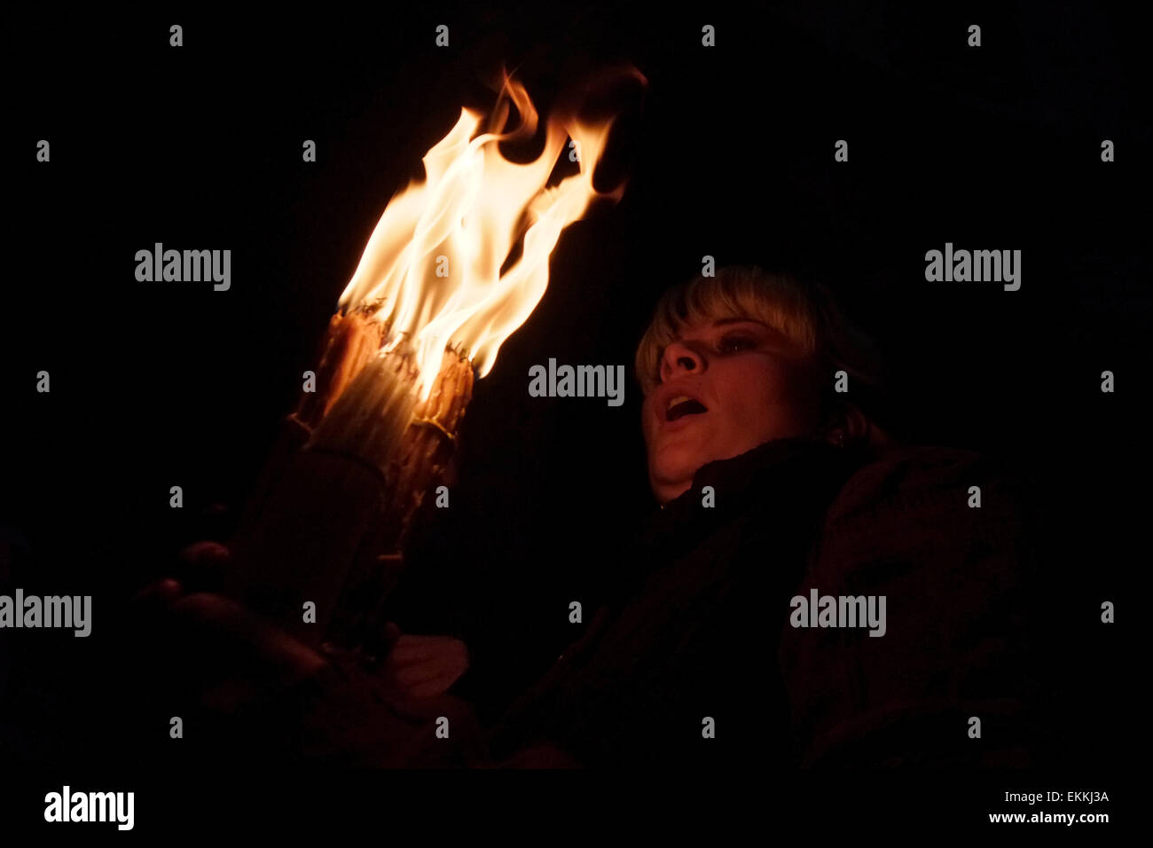 Christian Orthodox worshiper holds up candles lit from the Holy Fire ...