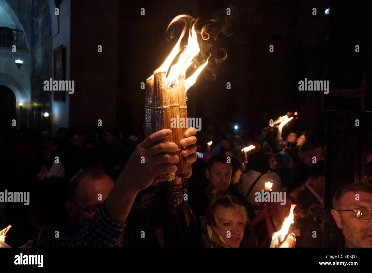 Christian Orthodox worshiper holds up candles lit from the Holy Fire ...