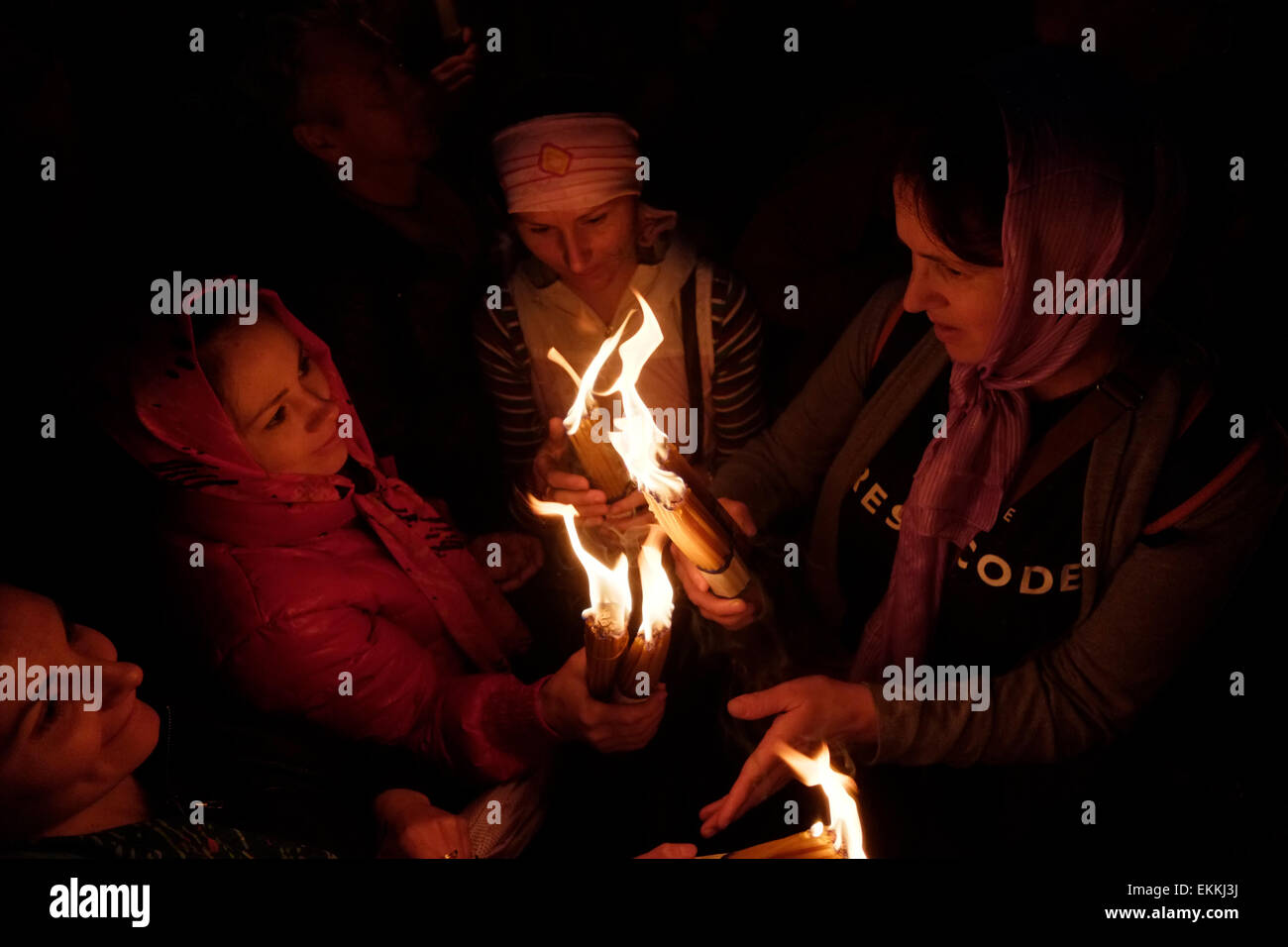 Christian Orthodox worshiper share the Holy Fire during Holy Saturday ...
