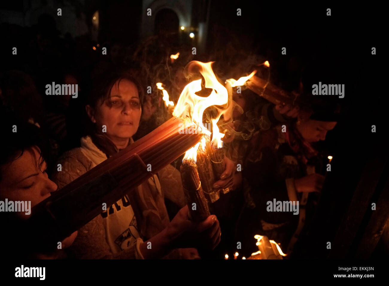 Christian Orthodox worshiper share the Holy Fire during Holy Saturday ...